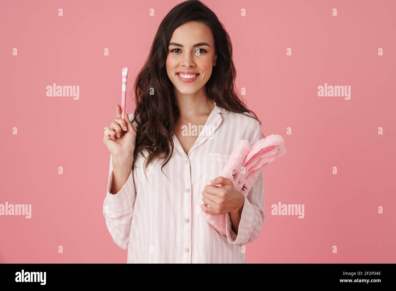 Happy beautiful woman in pajama posing with pen and bunny diary ...