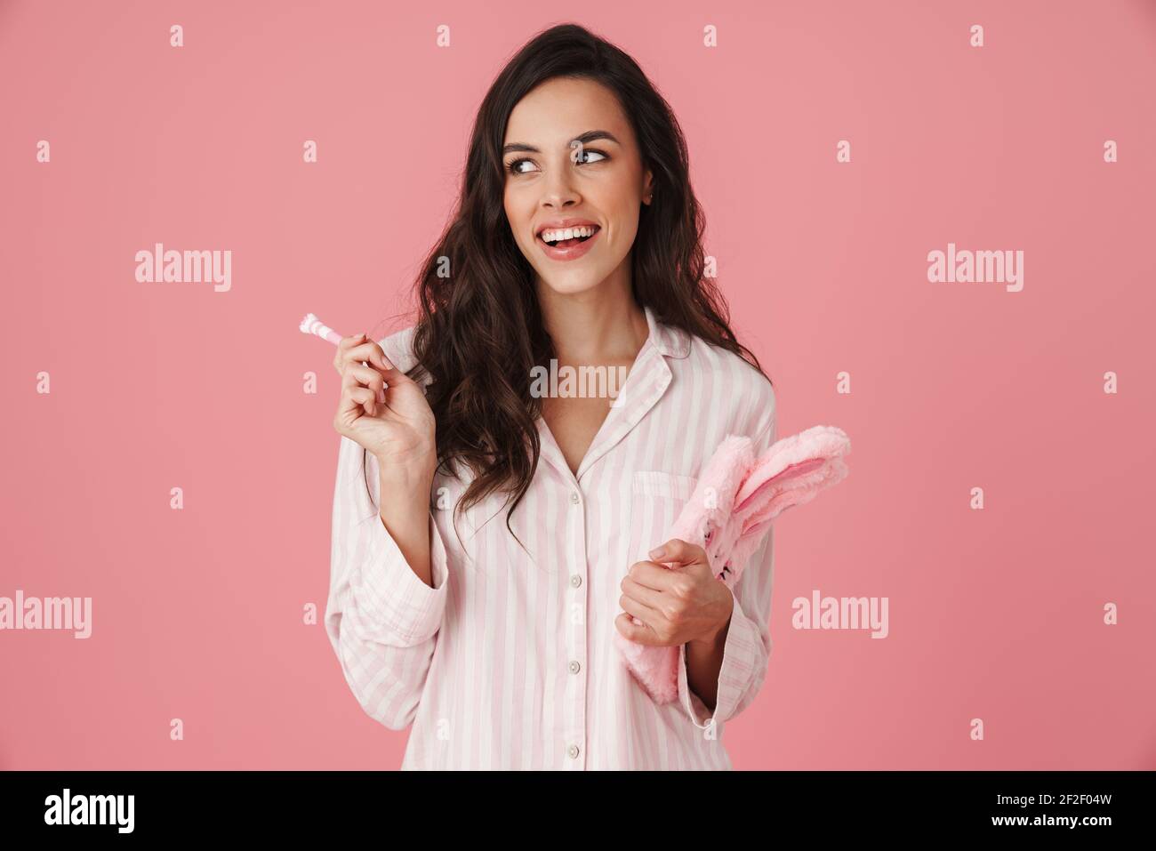 Happy beautiful woman in pajama posing with pen and bunny diary ...