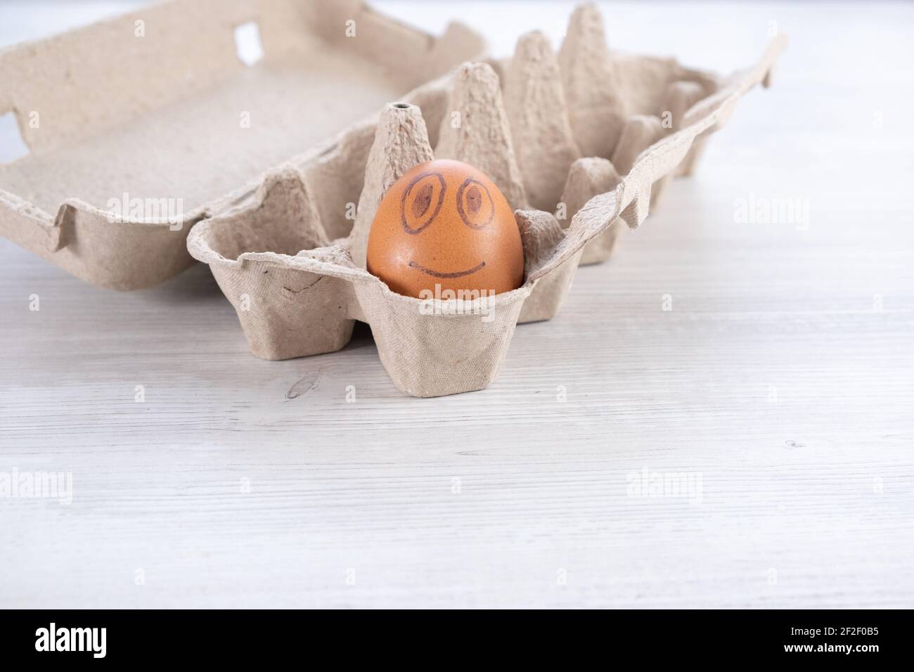 Smiling egg in a cardboard box Stock Photo - Alamy