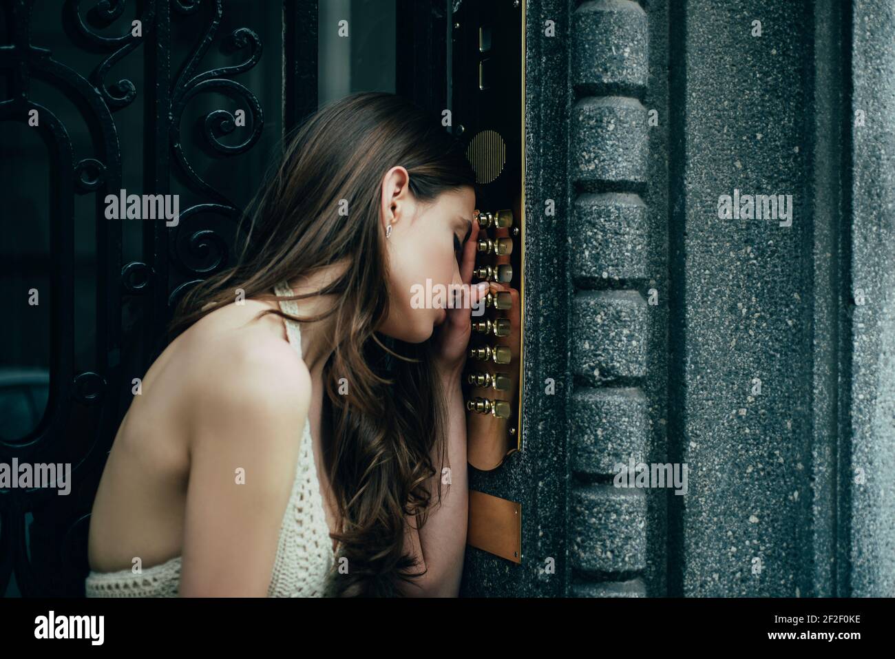 Lady woman intercom doorbell at building entrance. Young dress female ...