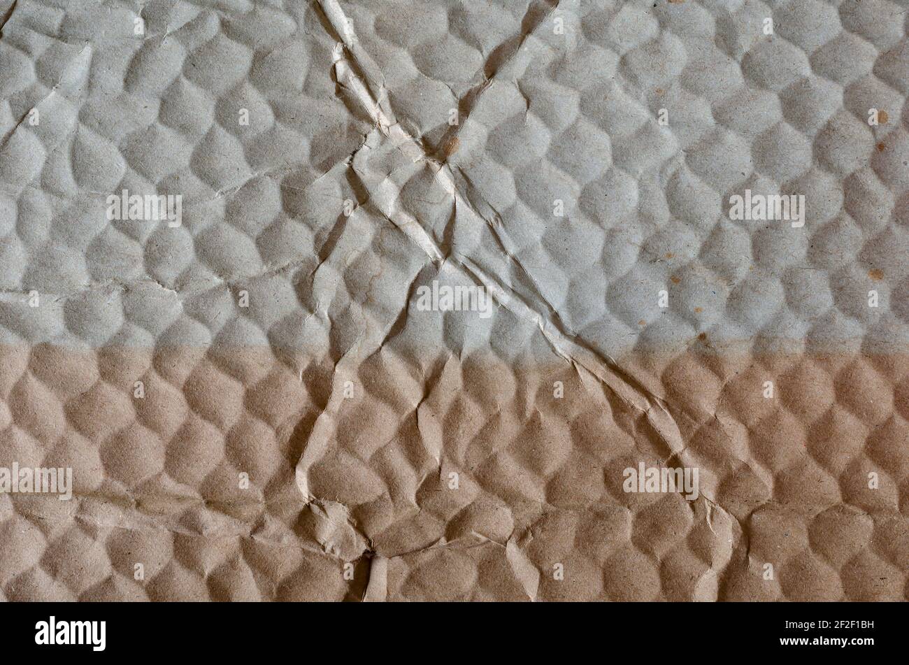 Two-tone old crumpled honeycomb cardboard. Pressed paper packaging ...