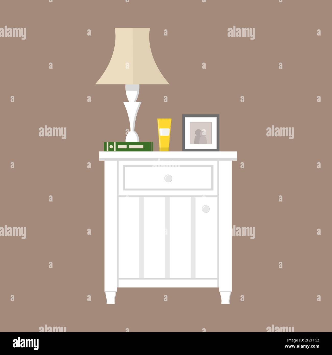 White wooden night table with lamp, book, cream and portrait in frame ...