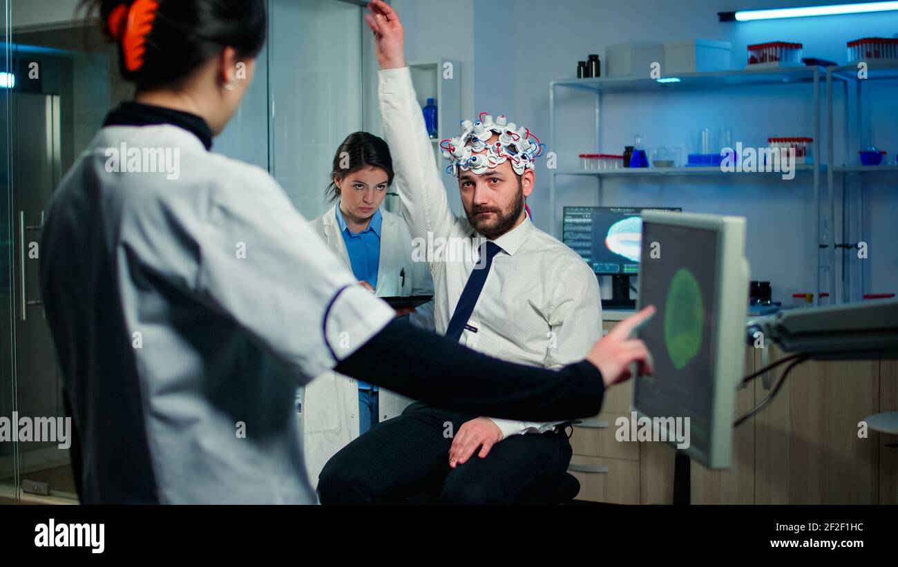 Man patient with high tech headset device participating at neurological ...