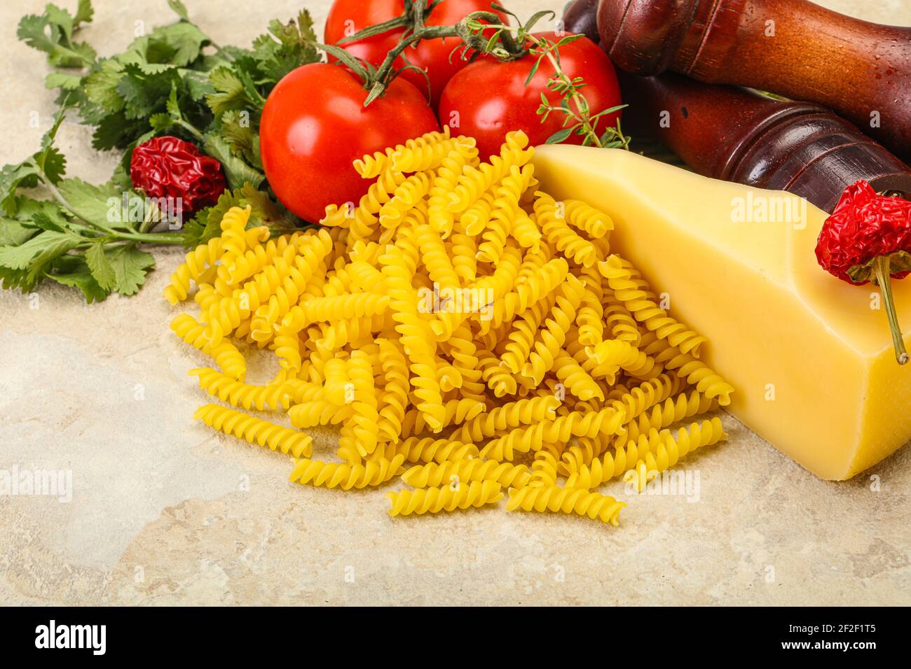 Raw Italian pasta Fusilli for cooking with vegetables Stock Photo - Alamy