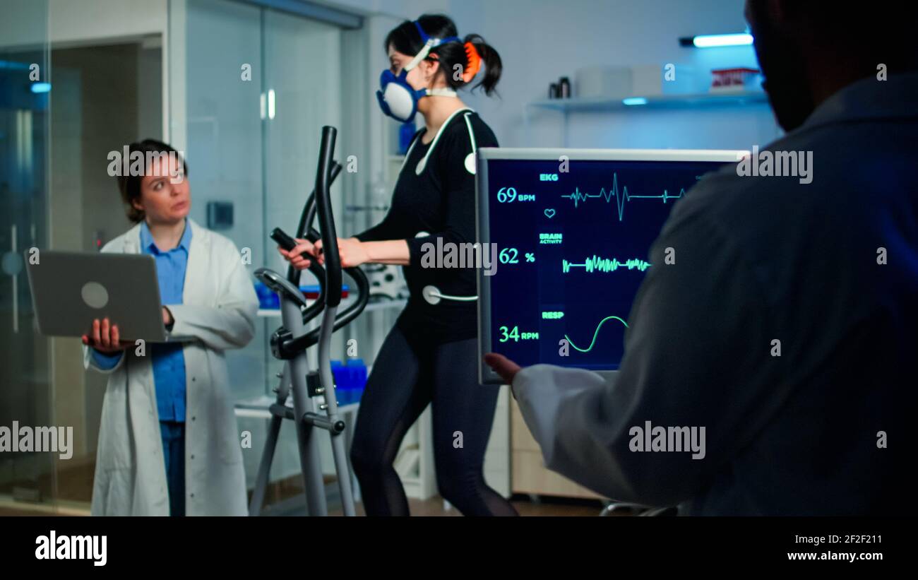 Doctor scientist holding laptop computer and controling EKG data ...