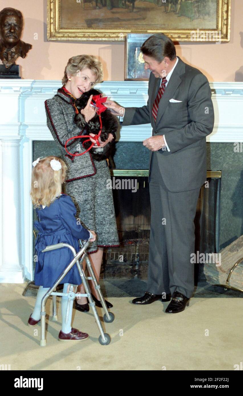President Ronald Reagan and Nancy Reagan holding a dog meeting with ...