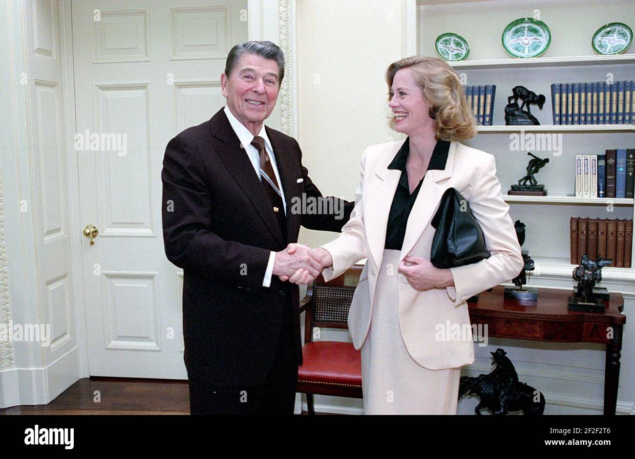 President Ronald Reagan greeting actress Cybill Shepherd in the Oval ...