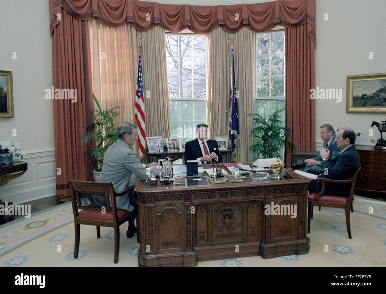 President Ronald Reagan in the Oval Office meeting with Ed Meese, Michael Deaver, and James ...