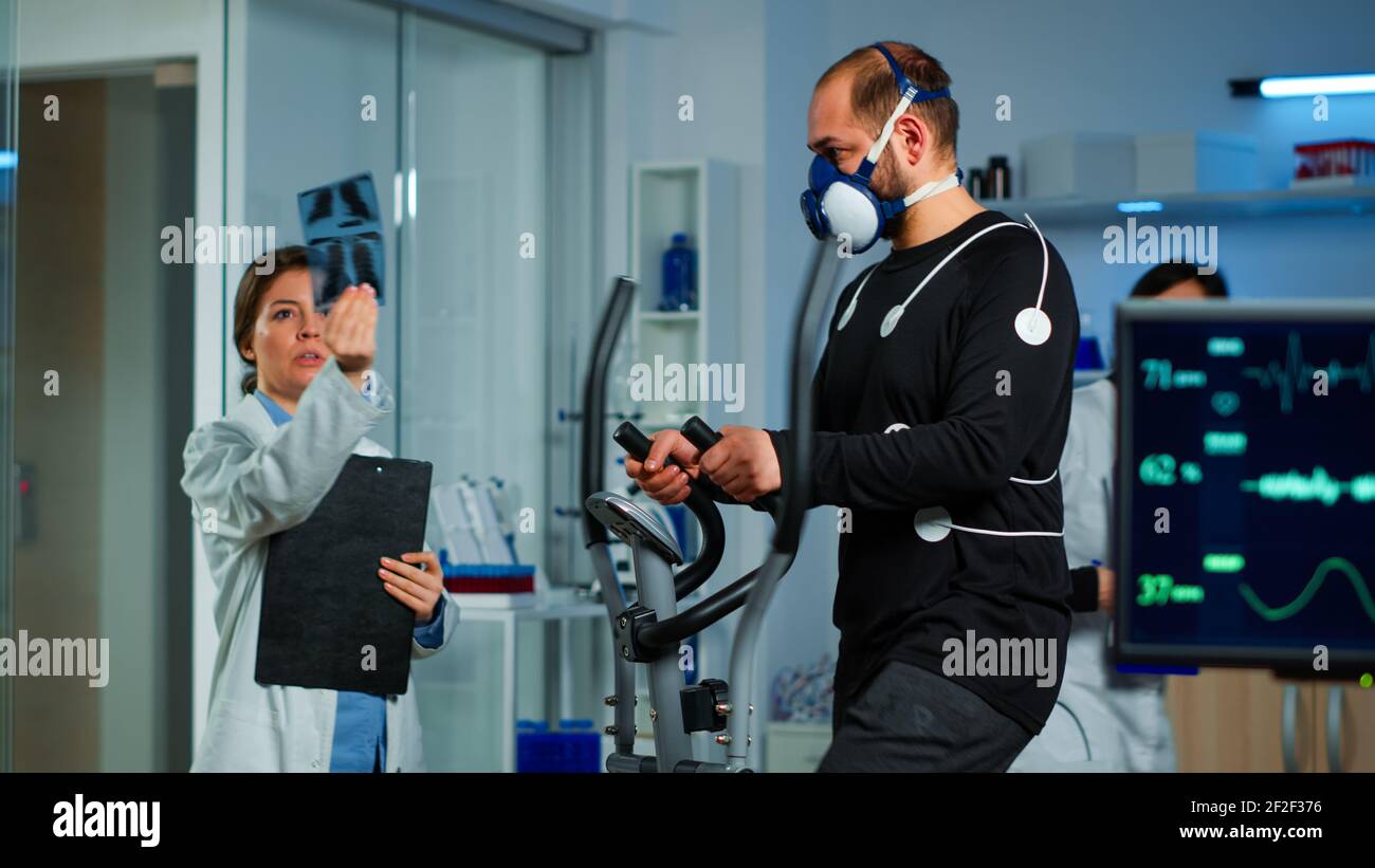 Medical doctors in sports science lab measuring performance ...