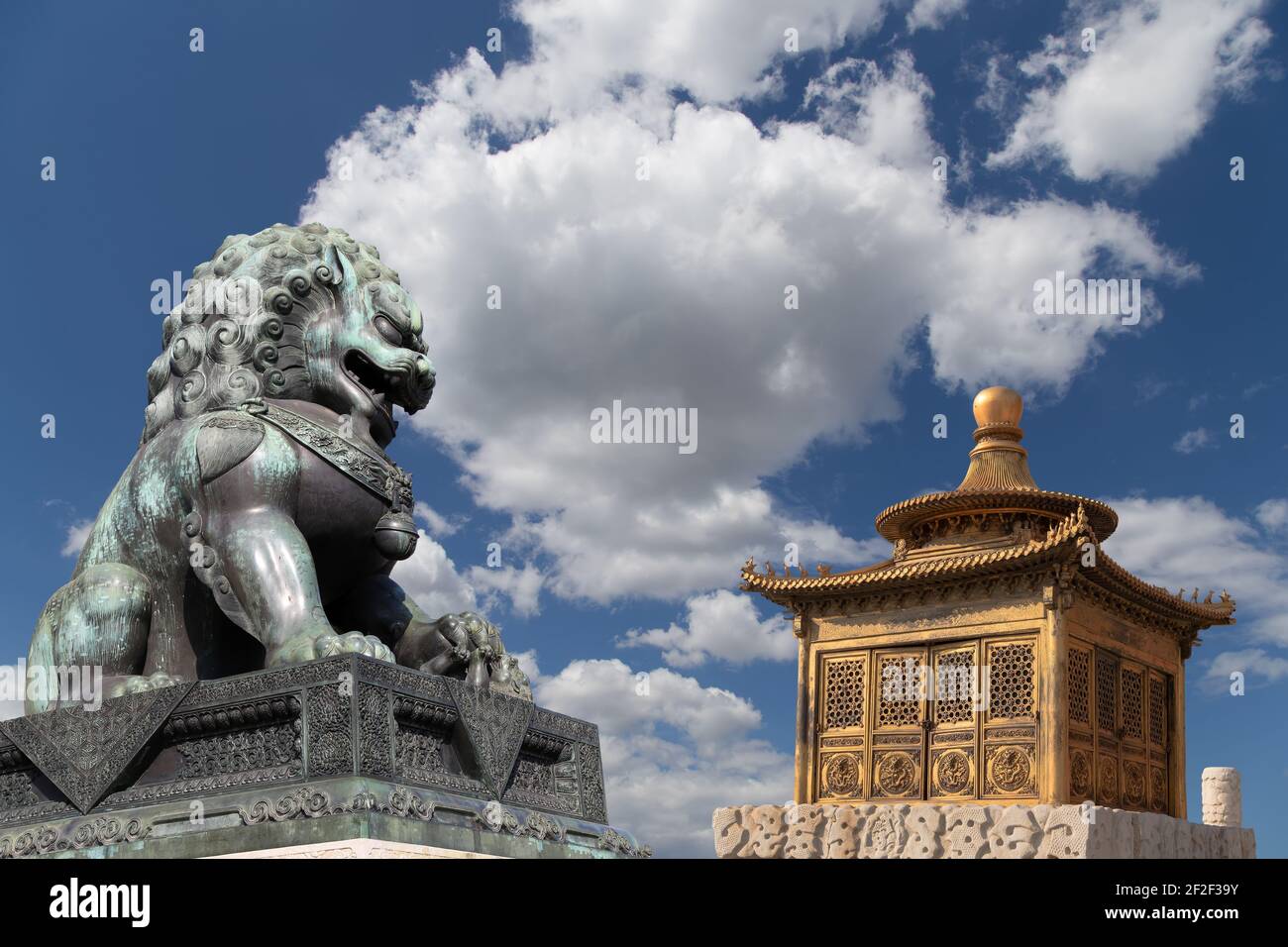 Bronze Guardian Lion Statue and bronze pagoda in the Forbidden City ...