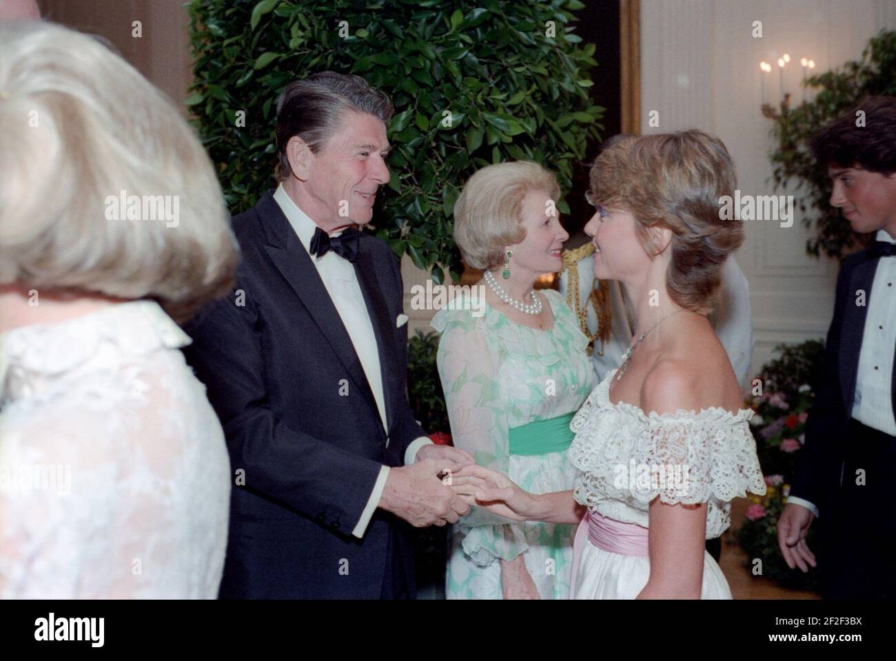 President Ronald Reagan shaking hands with Olivia Newton-John Stock ...