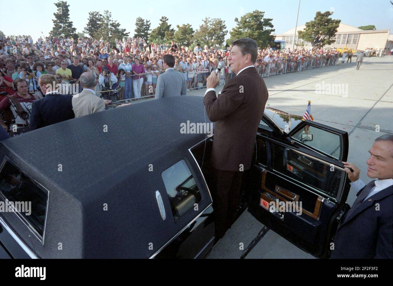 President Ronald Reagan speaking to the crowd from his limousine on a ...