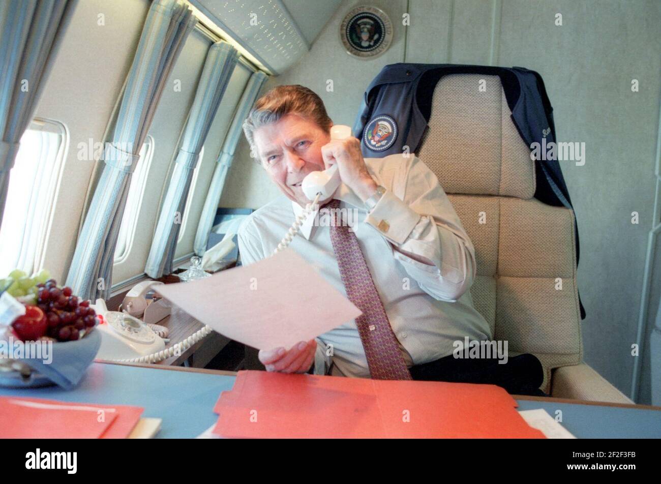 President Ronald Reagan talking on telephone in his state room on a ...