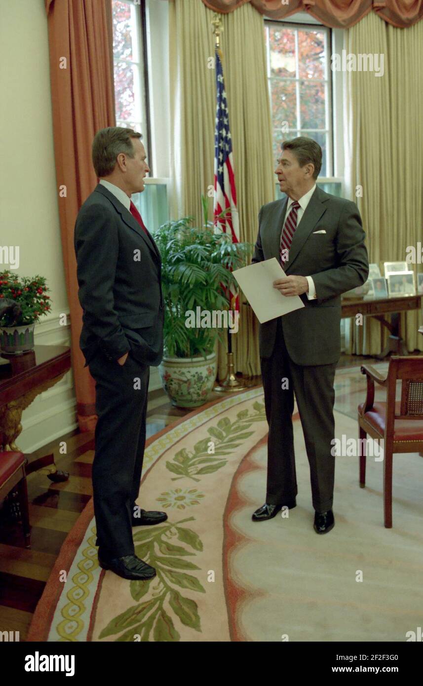 President Ronald Reagan talking with Vice President George H. W. Bush ...