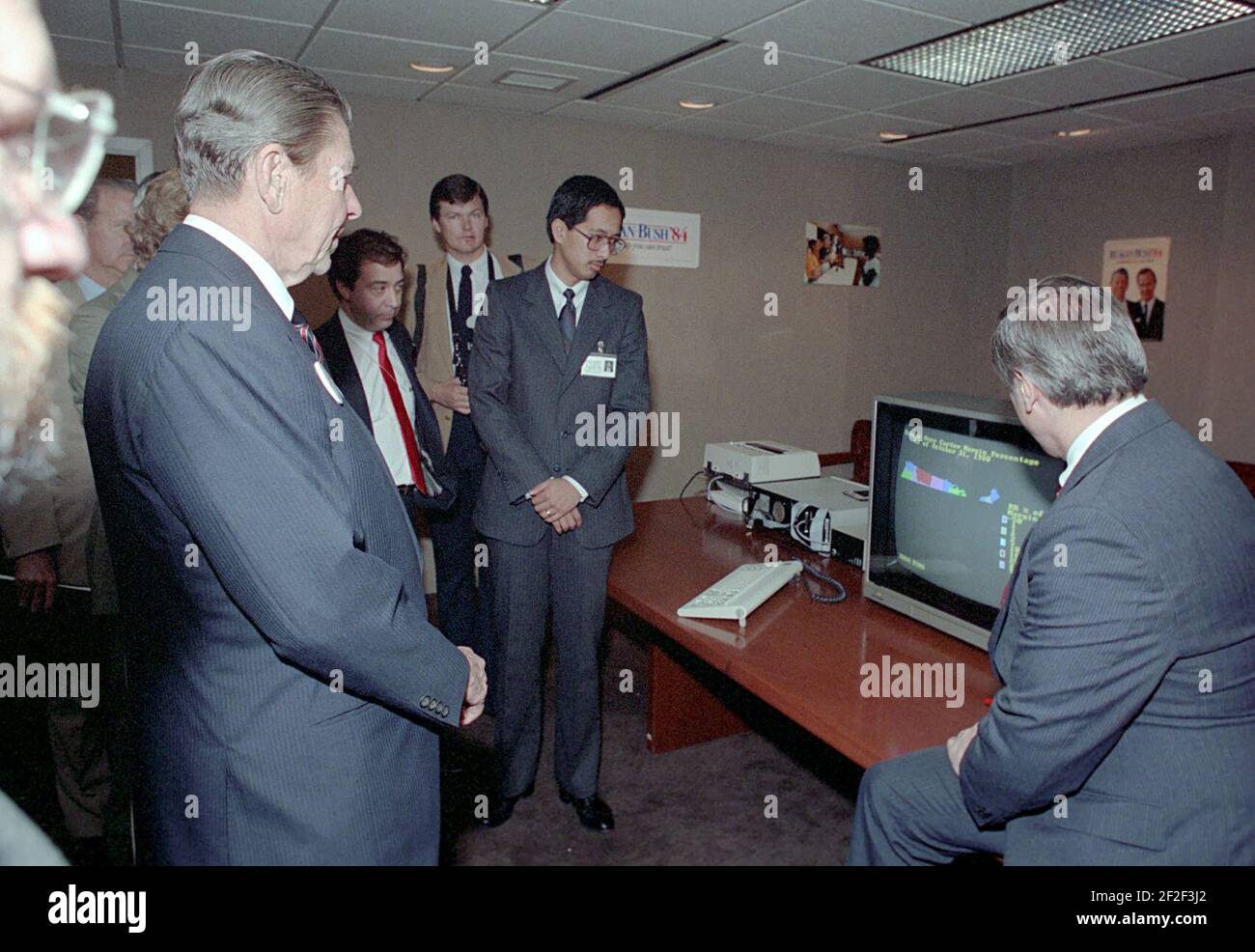 President Ronald Reagan watches a computer demonstration with Richard ...