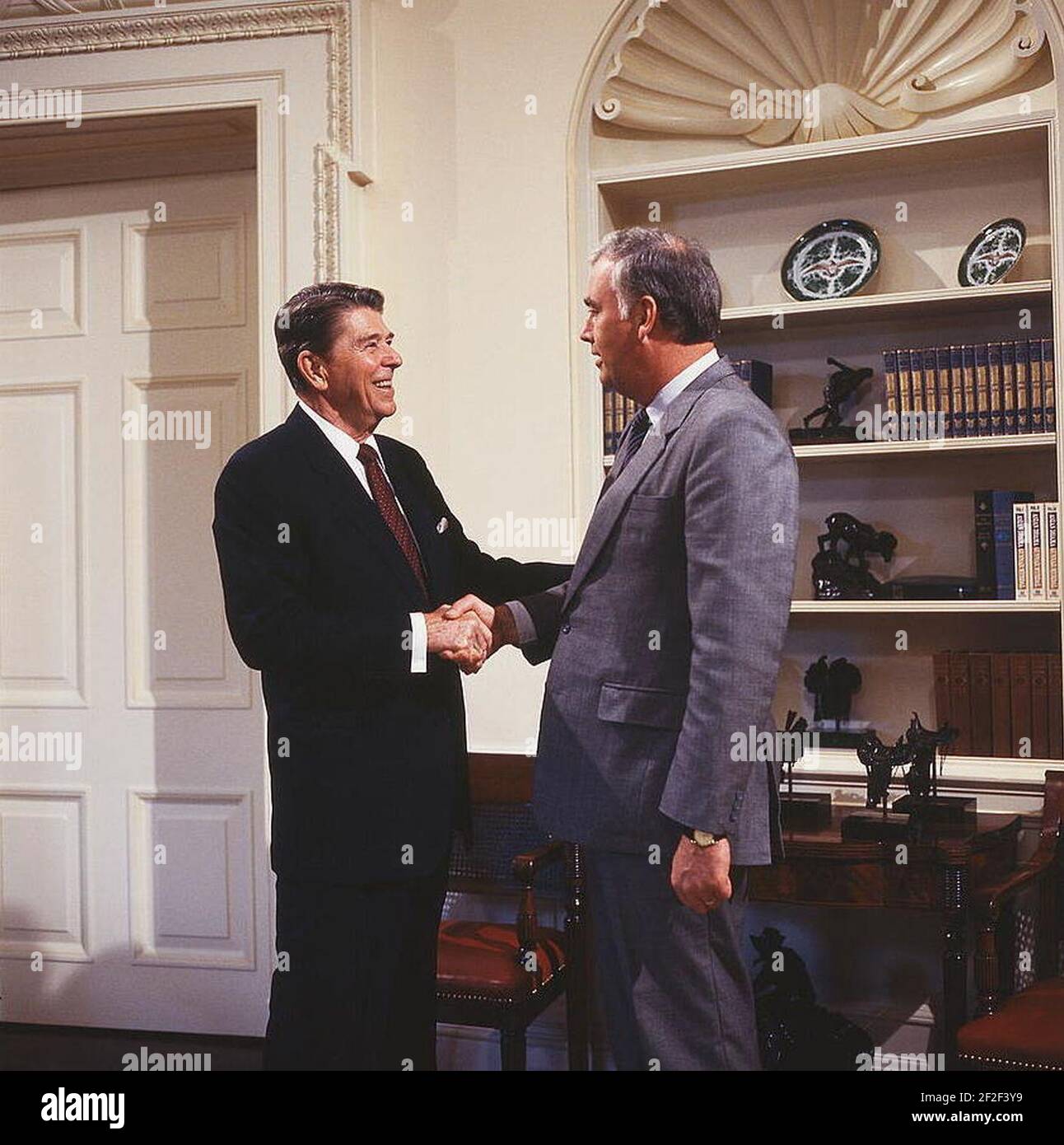 President Ronald Reagan, in the Oval Office, shaking hands with ...