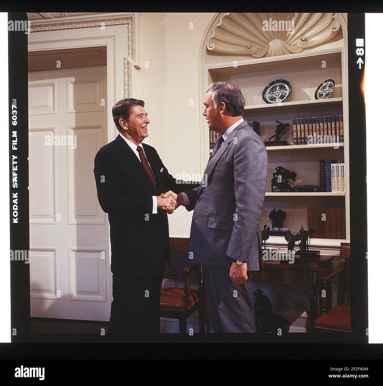 President Ronald Reagan, in the Oval Office, shaking hands with ...