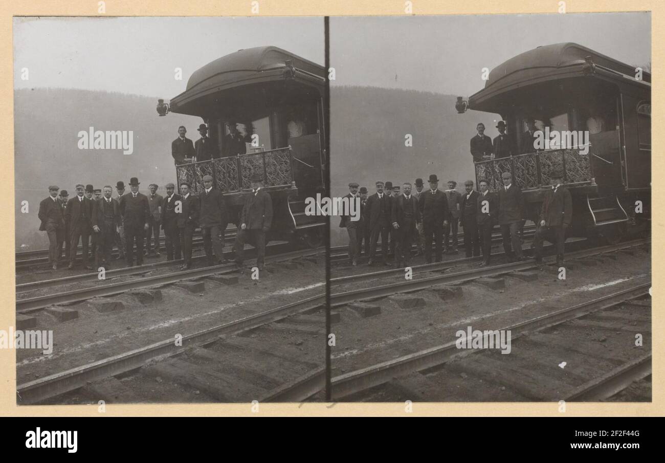 President Roosevelt, standing with twelve other men on railroad tracks ...