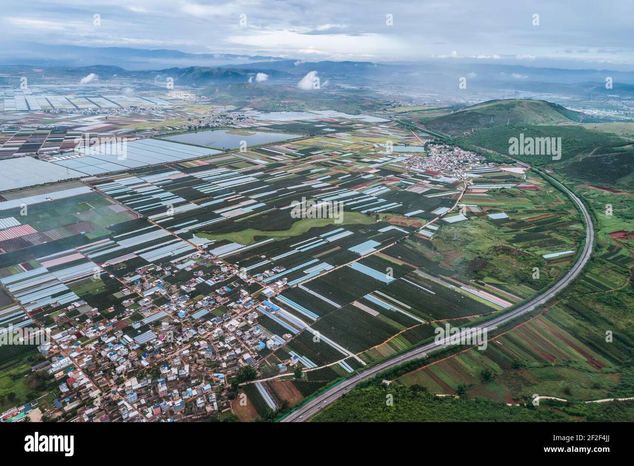 aerial view of agricultural plots of land under cultivation in an ...