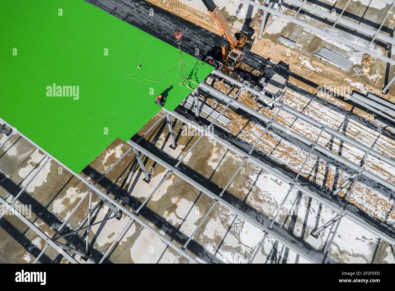 installation of a profile sheet on the roof of an industrial building ...
