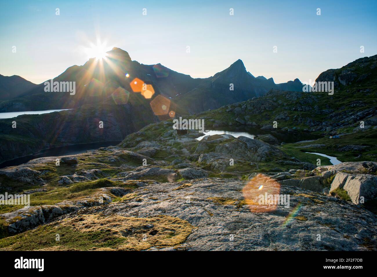 Setting sun over Munkebu and huts on Munken Trail in lofoten, Norway ...