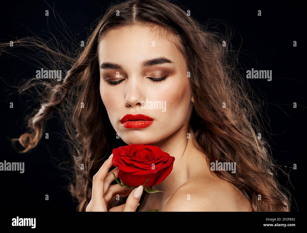 Charming woman with red rose eyeshadow bright makeup black background ...