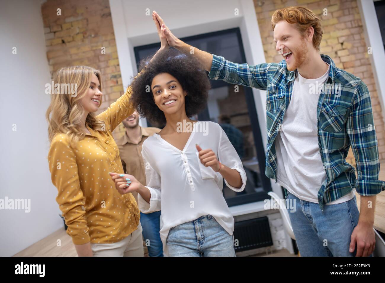 Team of young people working together and having a break Stock Photo ...