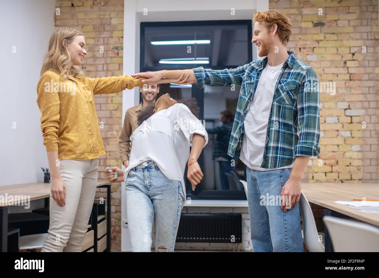 Team of young people working together and having a break Stock Photo ...