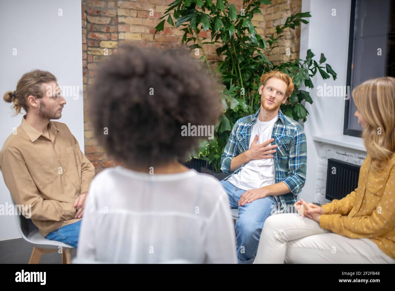 Group of people sitting in a circle and talking Stock Photo - Alamy