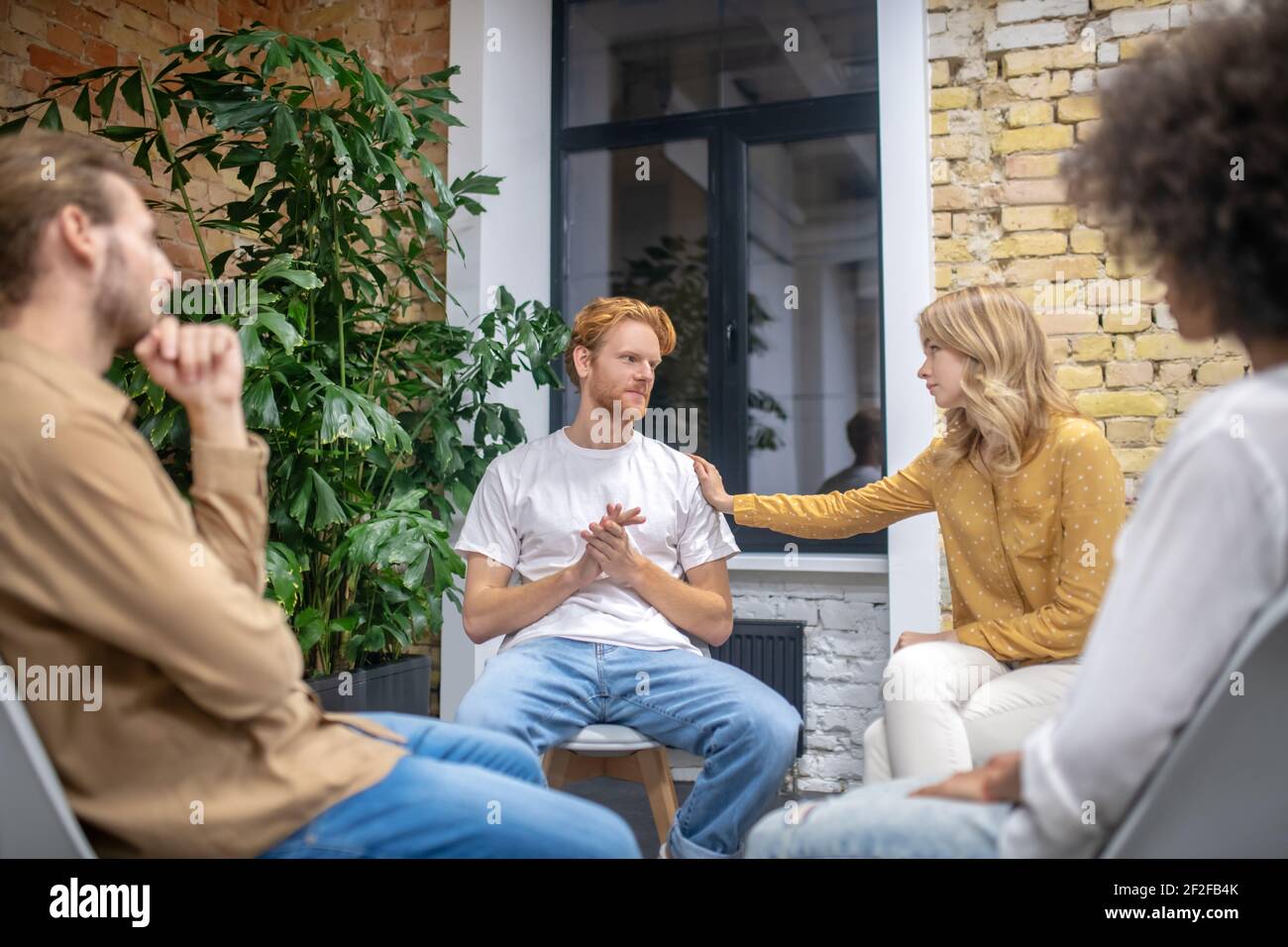 Group of people sitting in a circle and talking Stock Photo - Alamy