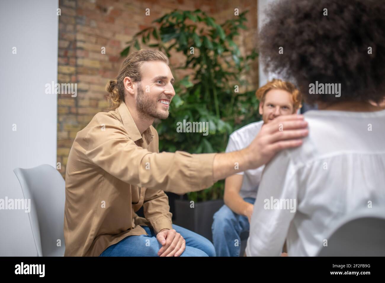Group members supporting each other and looking friendly Stock Photo ...