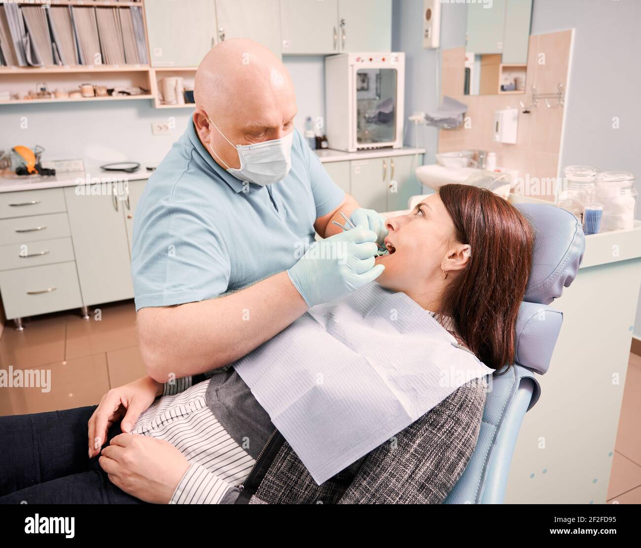 Doctor examining female patient teeth in dental office Stock Photo - Alamy