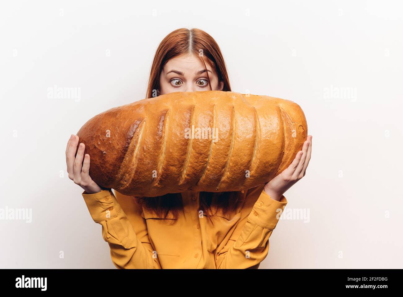 happy woman with a loaf of bread in hand a loaf in a horizontal ...