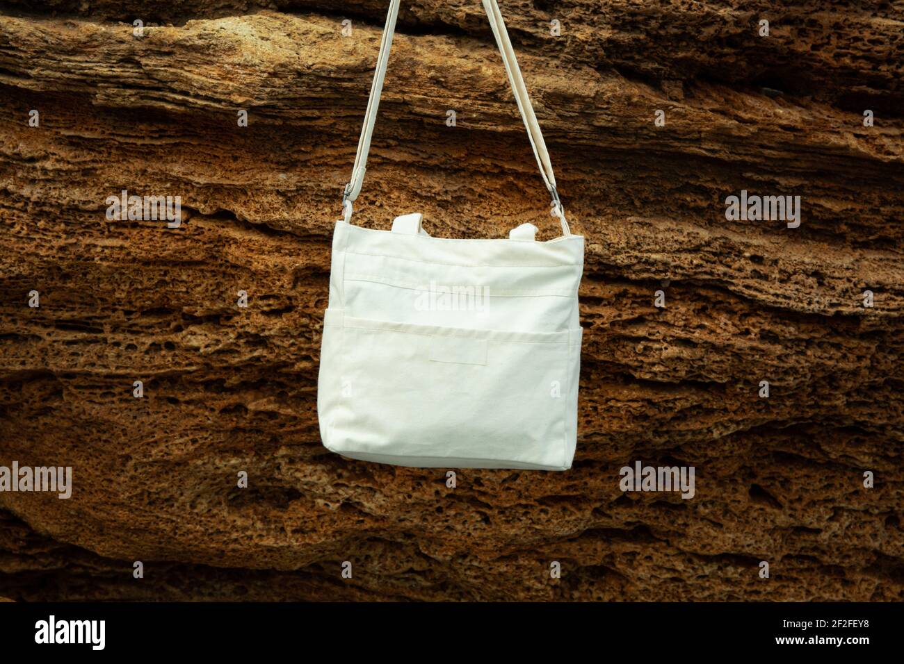 Stylish eco bag against big sea stone Stock Photo - Alamy