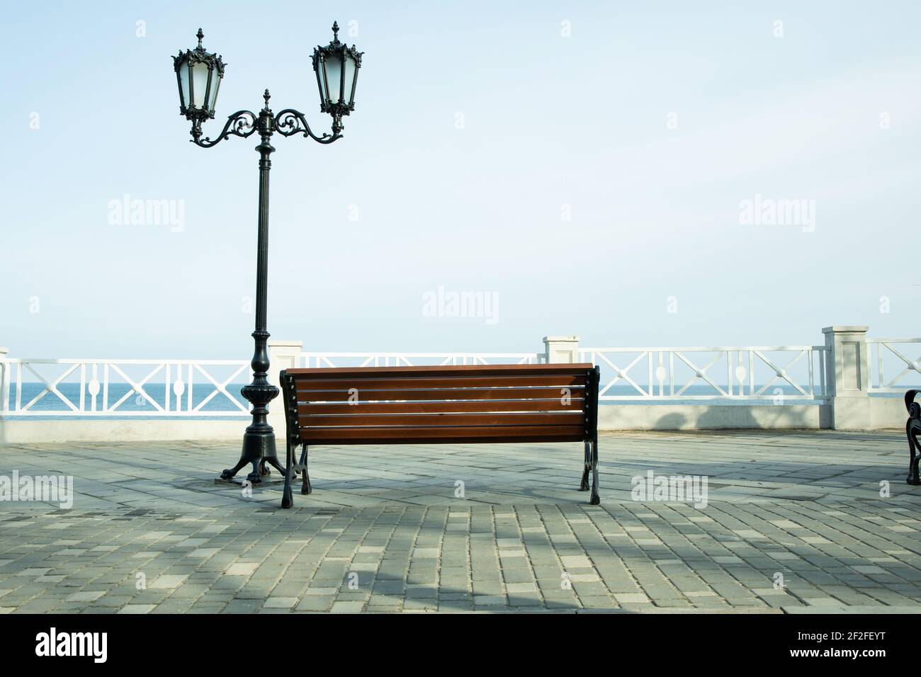Embankment with benches and lamp post with view on sea Stock Photo - Alamy