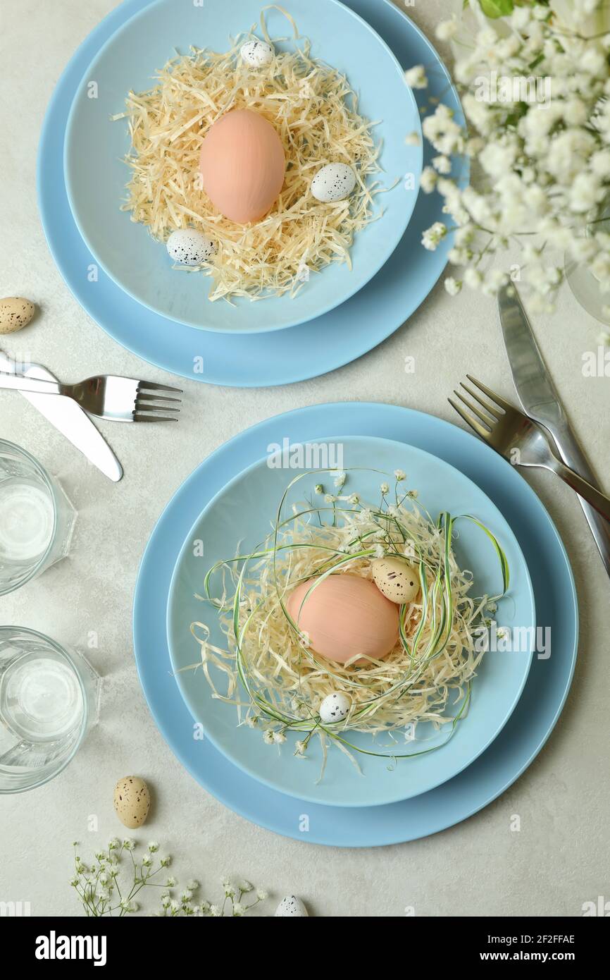 Happy Easter table setting with eggs on white textured table Stock ...