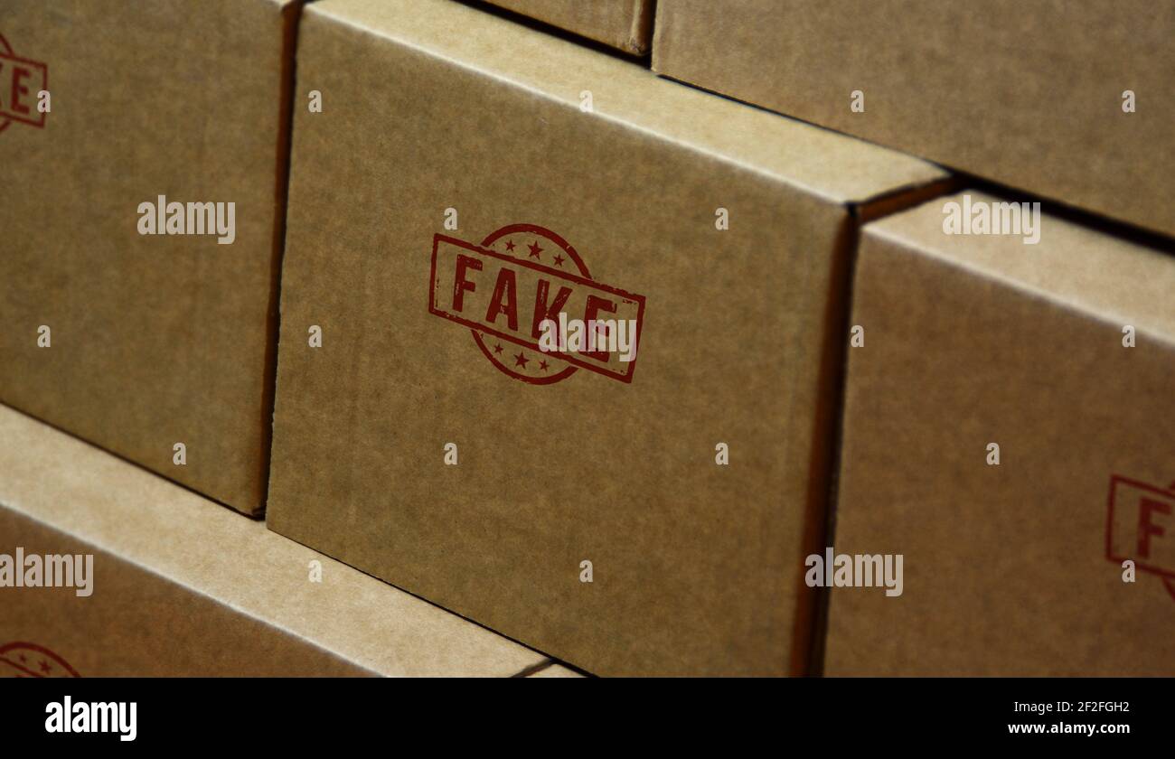 Fake stamp printed on cardboard box. Fraud, imitation and fake news ...