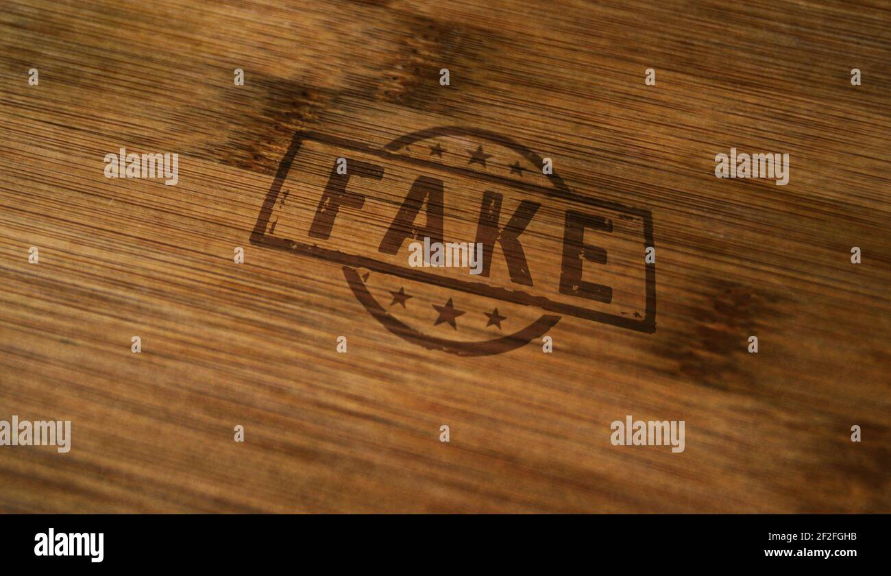 Fake stamp printed on wooden box. Fraud, imitation and fake news ...