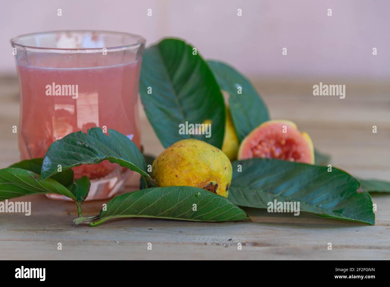 Glass of guava juice. Detox juice. Natural and refreshing drink. Guavas ...