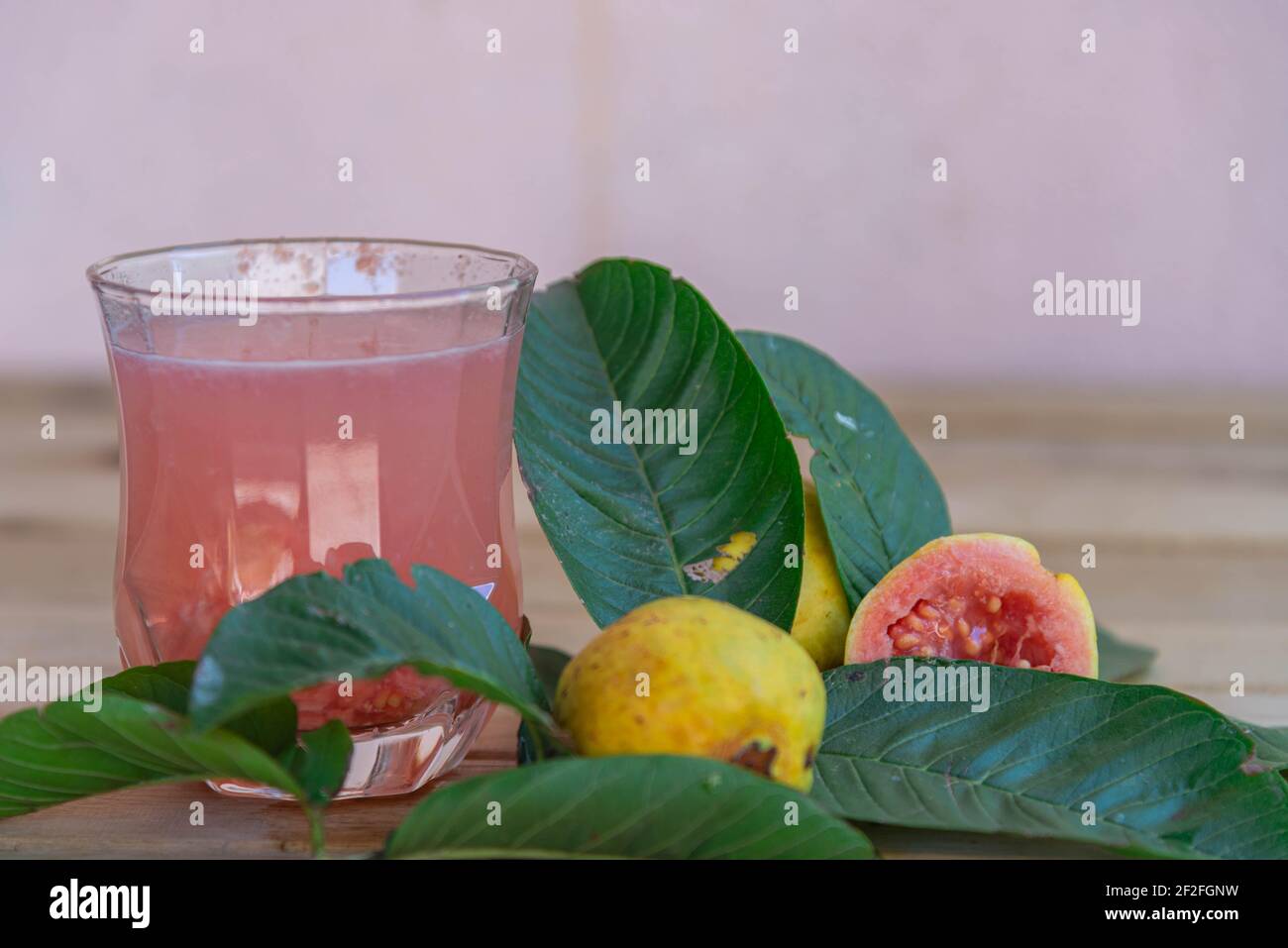 Glass of guava juice. Detox juice. Natural and refreshing drink. Guavas ...