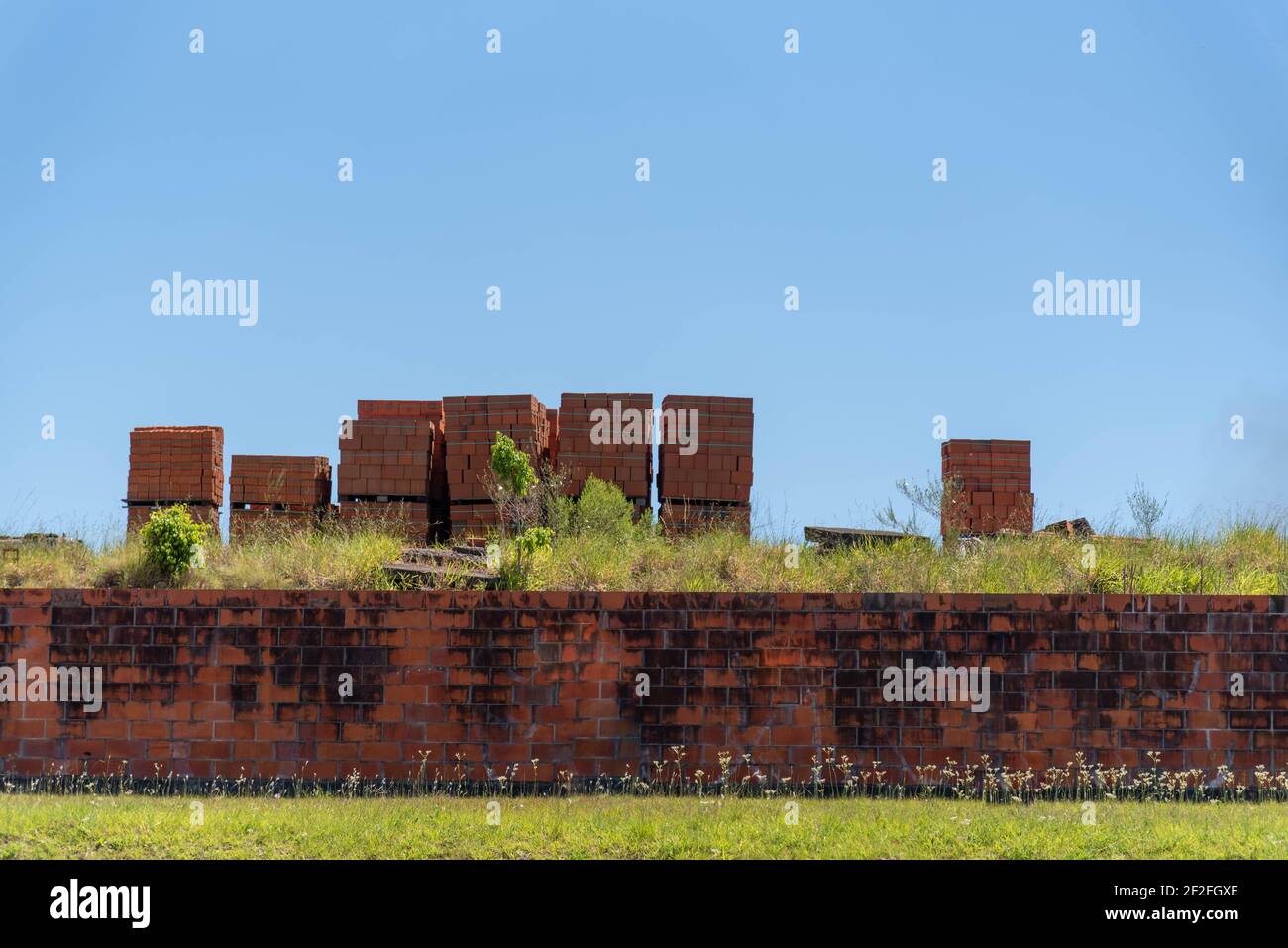 Masonry wall. Brick factory. Bricks stacked in paddle for transport ...