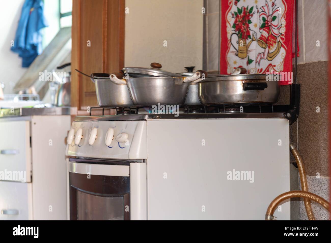 Pans on the fire. Gas oven. Kitchen utensils. Lunch being prepared ...