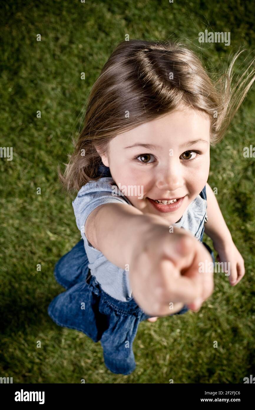 Girl pointing at viewer Stock Photo - Alamy