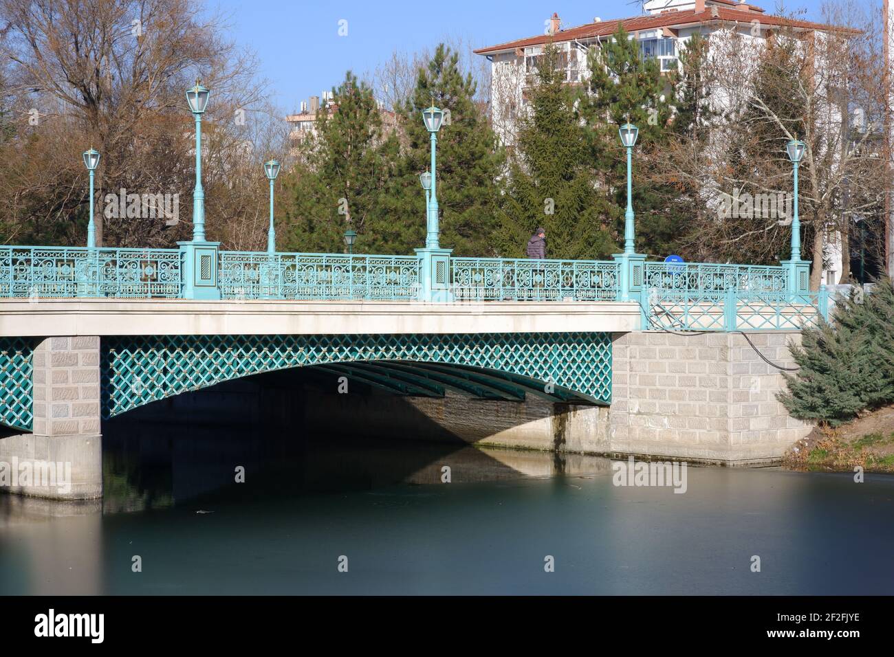 Green Bridge over frozen river Stock Photo - Alamy