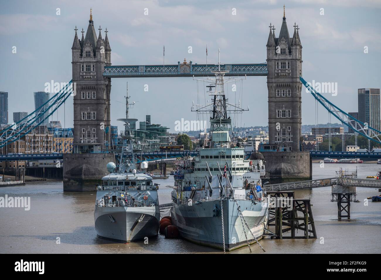 HMS Tamar a new patrol vessel is moored next to HMS Belfast on the ...