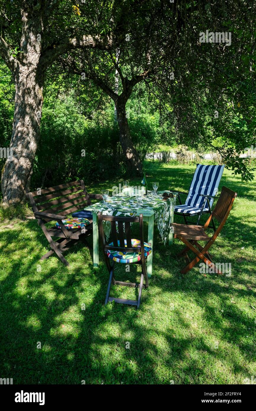 Sweden, Upplan, Vattholma, summer, garden table and chairs Stock Photo ...