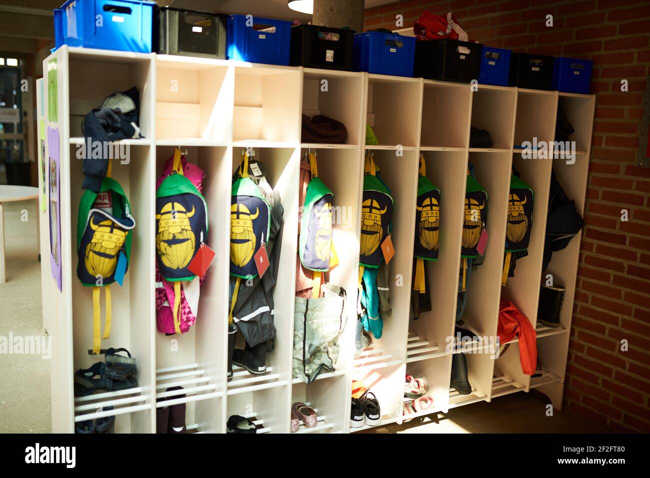 Kids personal clothes and backpack rack at school Stock Photo - Alamy