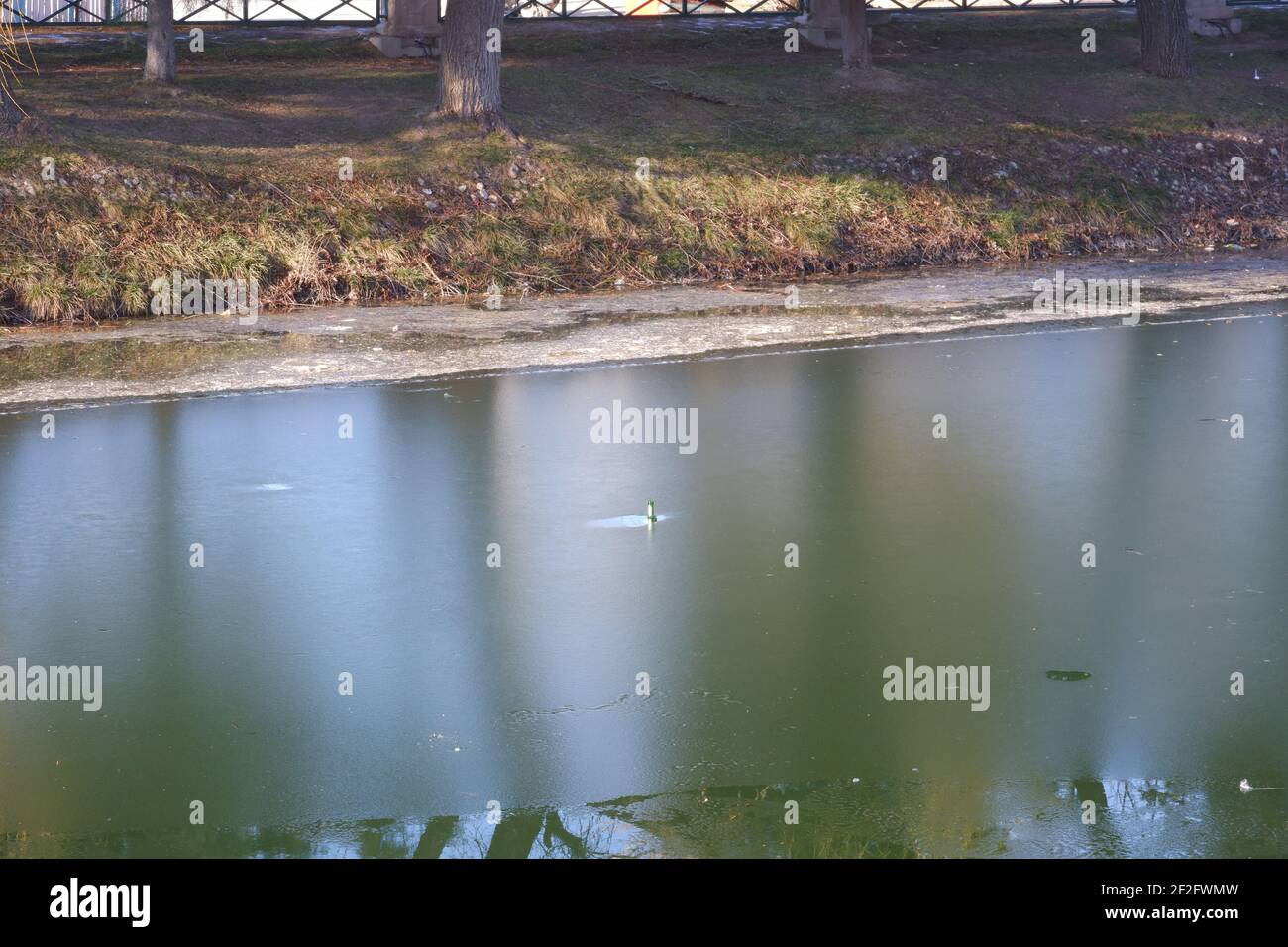 Bottle Floating on Frozen River Stock Photo - Alamy