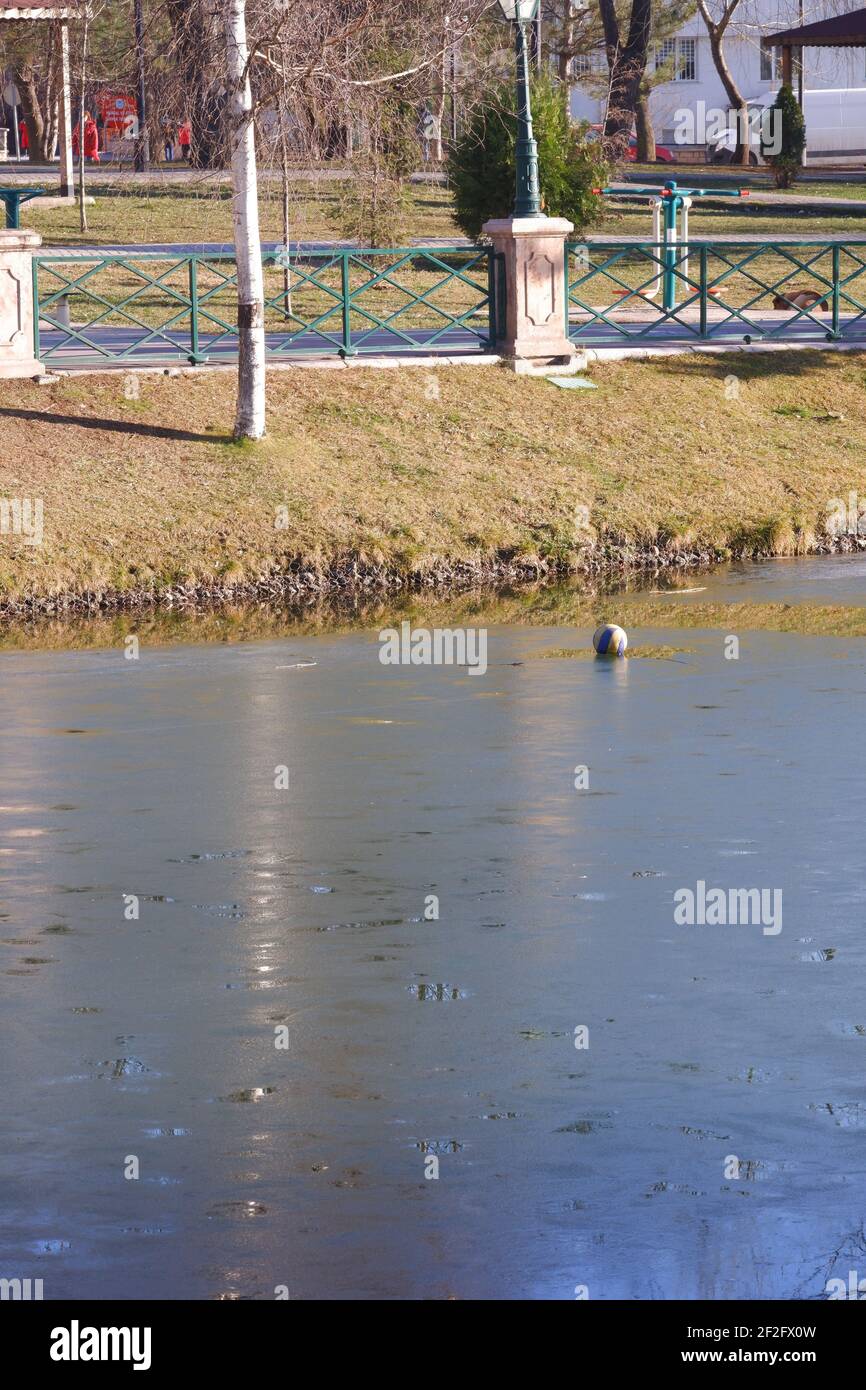 Ball Floating on Frozen River at park Stock Photo - Alamy