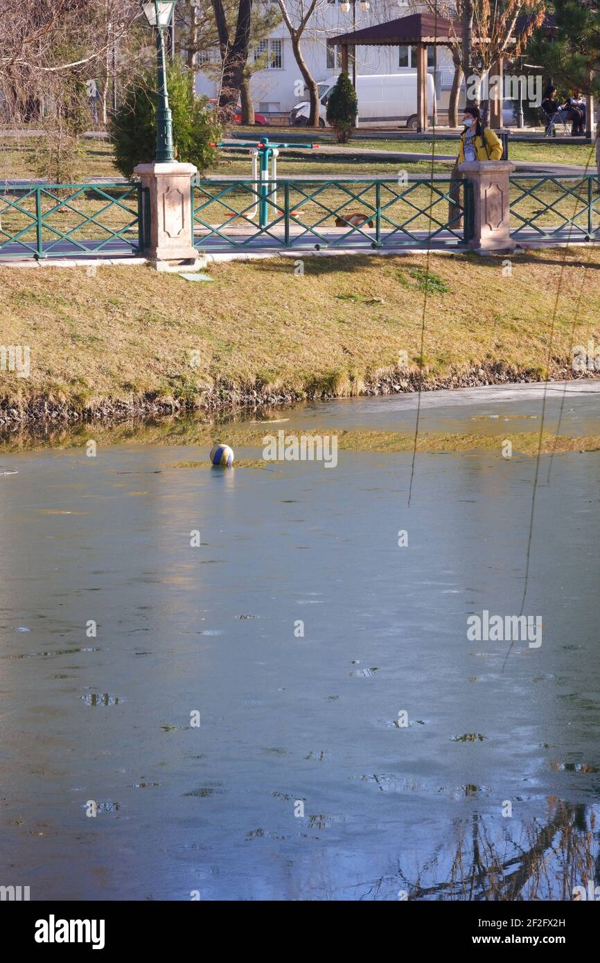 Ball Floating on Frozen River at park Stock Photo - Alamy